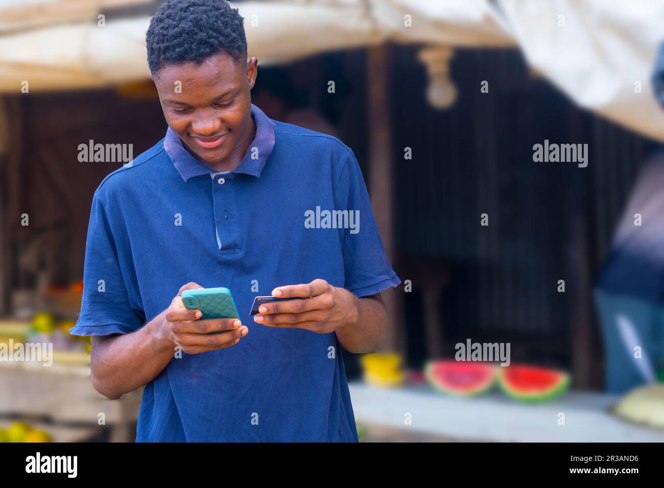 copy space image of Young black man using his mobile phone and credit ...