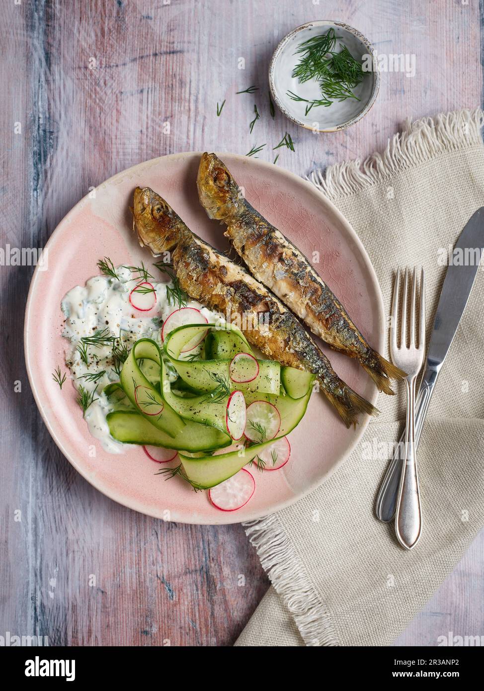 Grilled sardines with pickled cucumber Stock Photo - Alamy