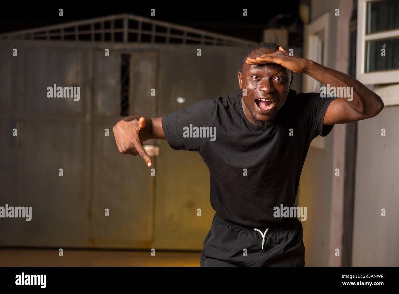 Excited young African man smiling pointing fingers aside at copy space ...