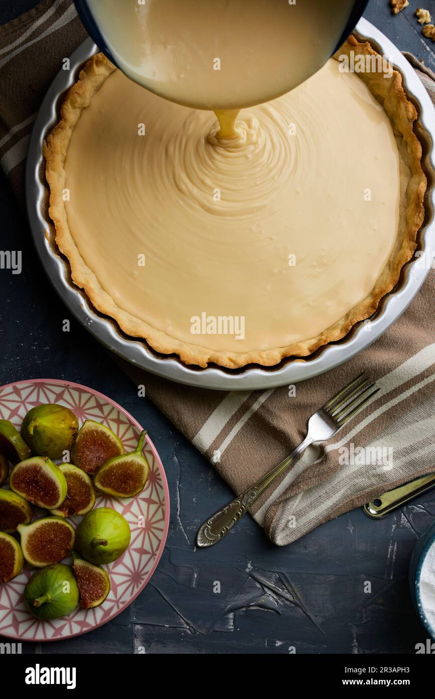Pouring mascarpone filling in tart shell Stock Photo - Alamy