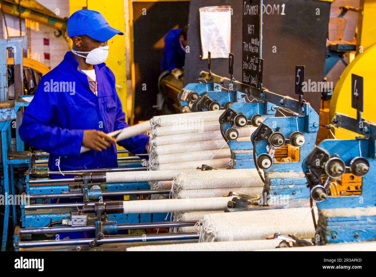 African factory worker on a copwinder weft assembly line loom Stock ...