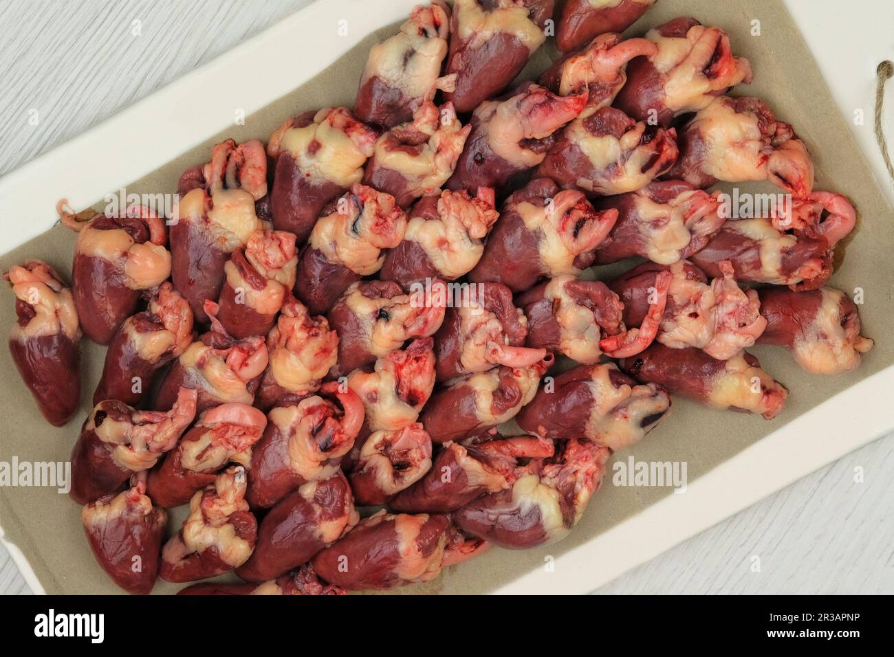 Chicken hearts in board on wooden background. Raw meat. Top view Stock ...