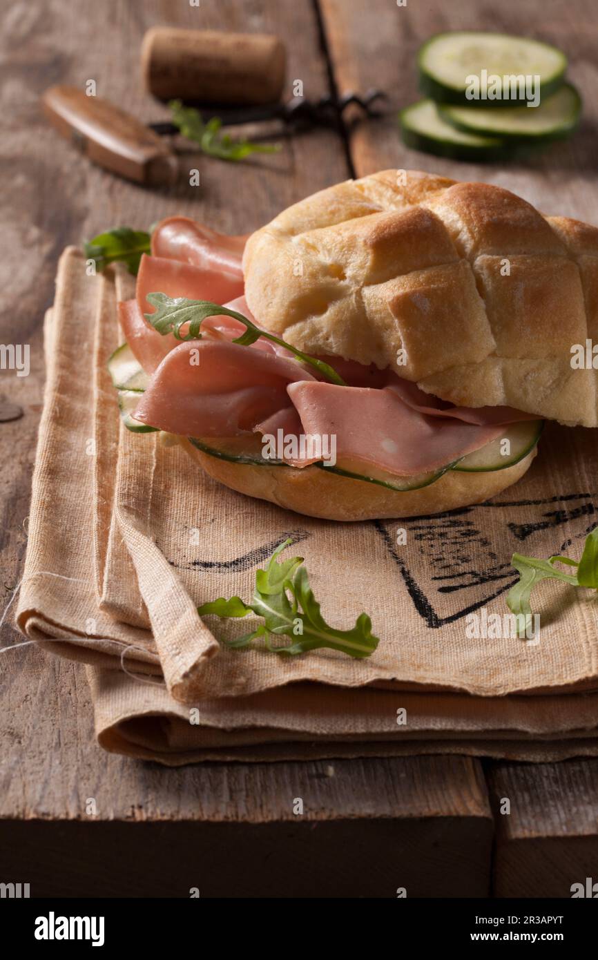 A bread roll with mortadella, cucumber and rocket Stock Photo - Alamy