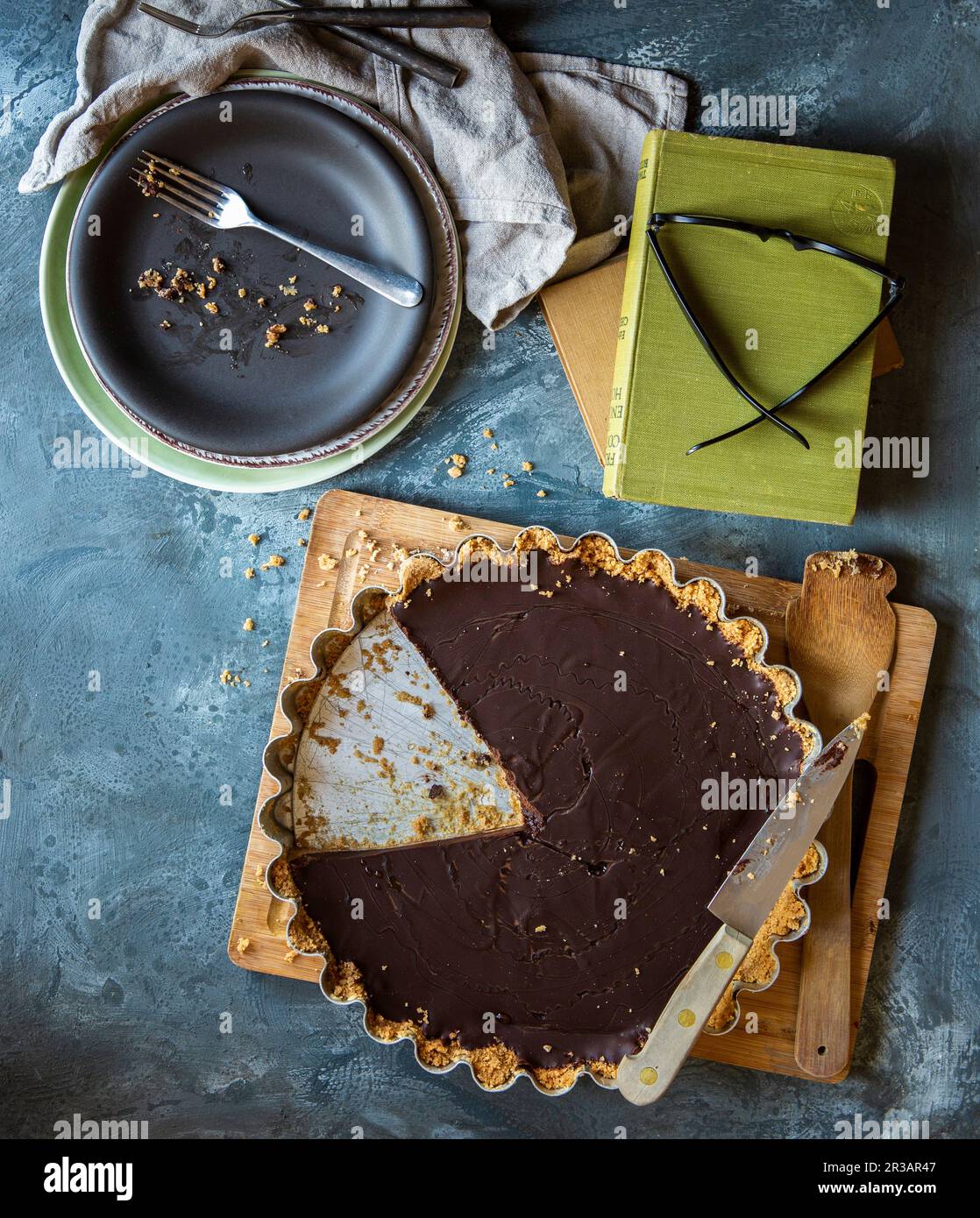 Chocolate tart with biscuit base and slice removed Stock Photo - Alamy