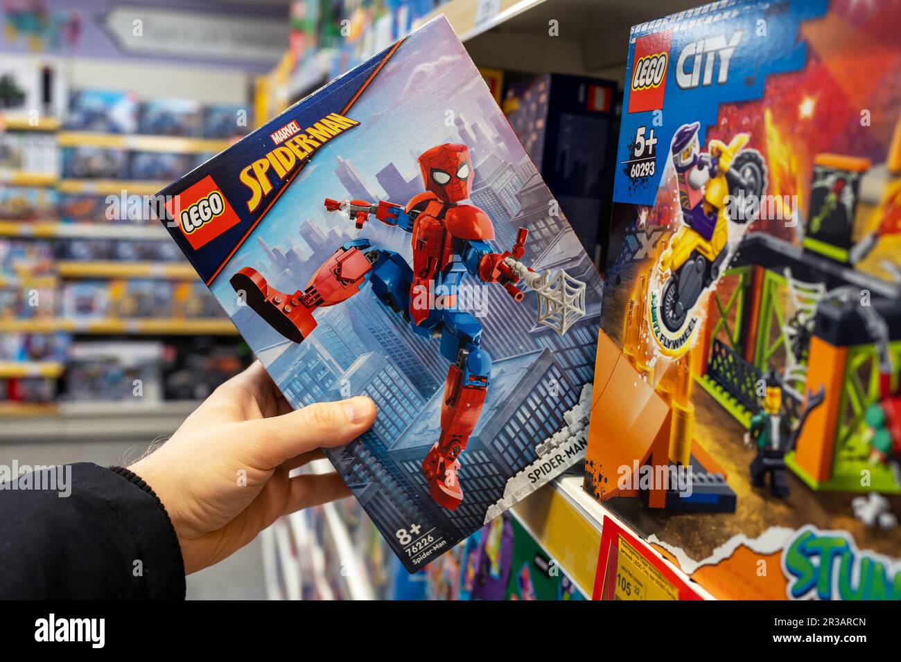 Lego Spiderman in hands of buyer. Spiderman toy in a toy store. Minsk ...