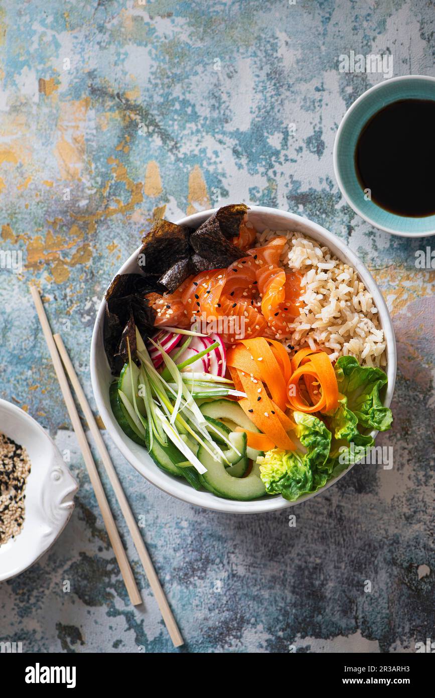 Sushi buddha bowl with salmon, brown sushi rice, nori nori, cucumber ...
