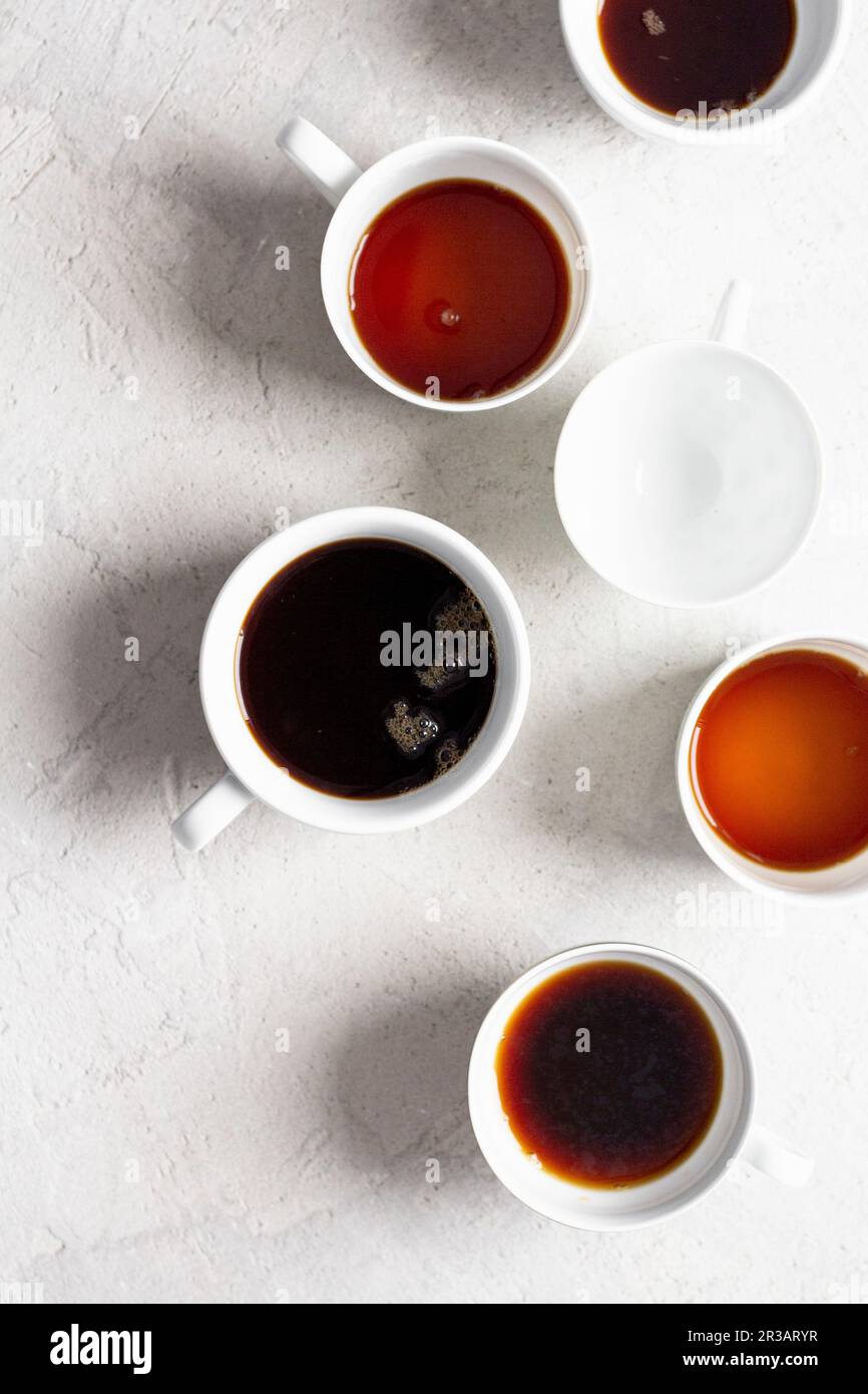 Coffee cups, filled to different levels Stock Photo - Alamy
