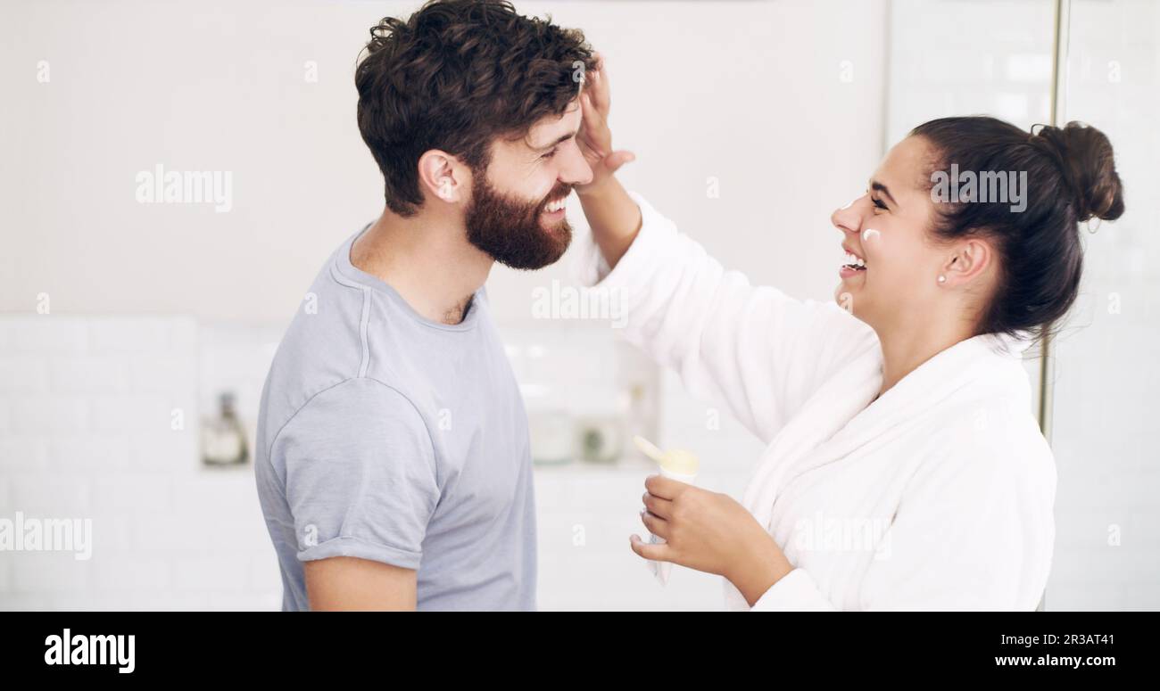 Couple, face skincare cream and bathroom with smile, helping hand and ...