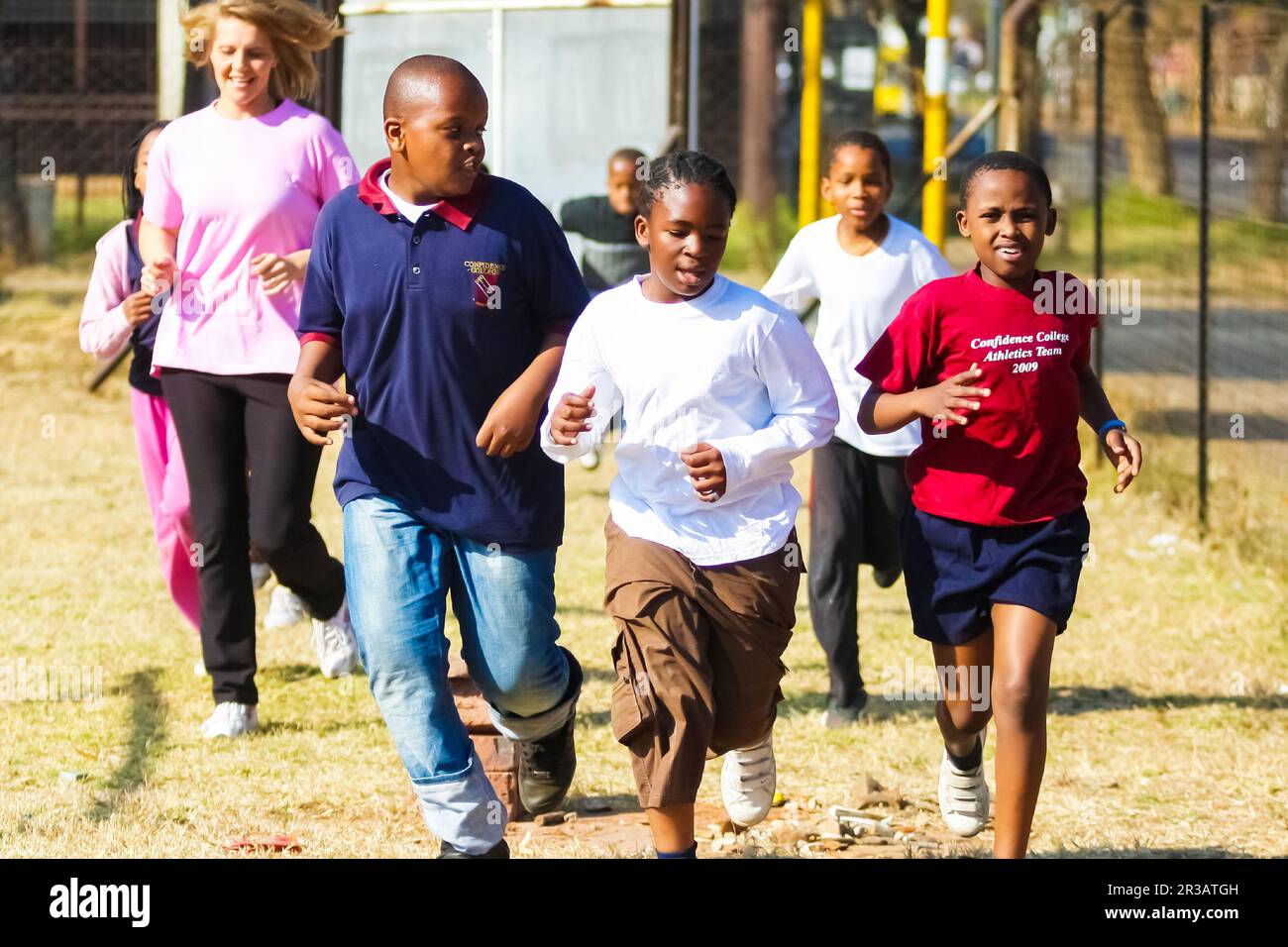 Diverse African Primary School children doing physical exercise PT ...