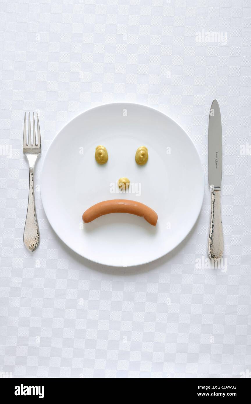 A sad face made from a sausage and mustard Stock Photo - Alamy
