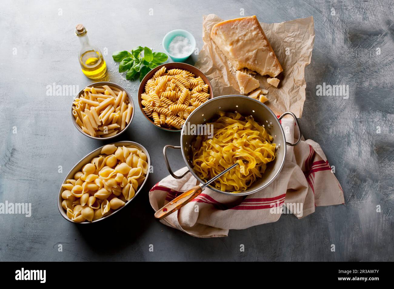 Different types of pasta, parmesan, salt, basil and olive oil Stock ...