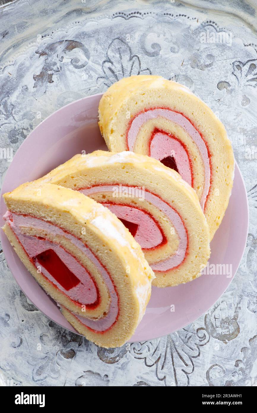 Sponge roll roulade with jelly and raspberry foam Stock Photo - Alamy