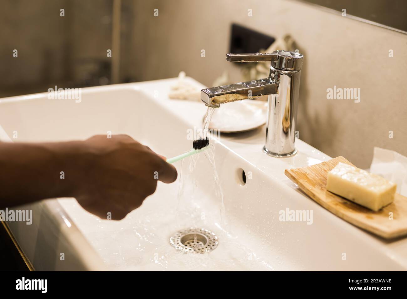 African american male hand holding toothbrush with toothpaste applied ...