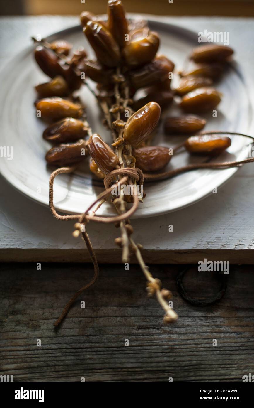 Date bunches on a plate Stock Photo - Alamy