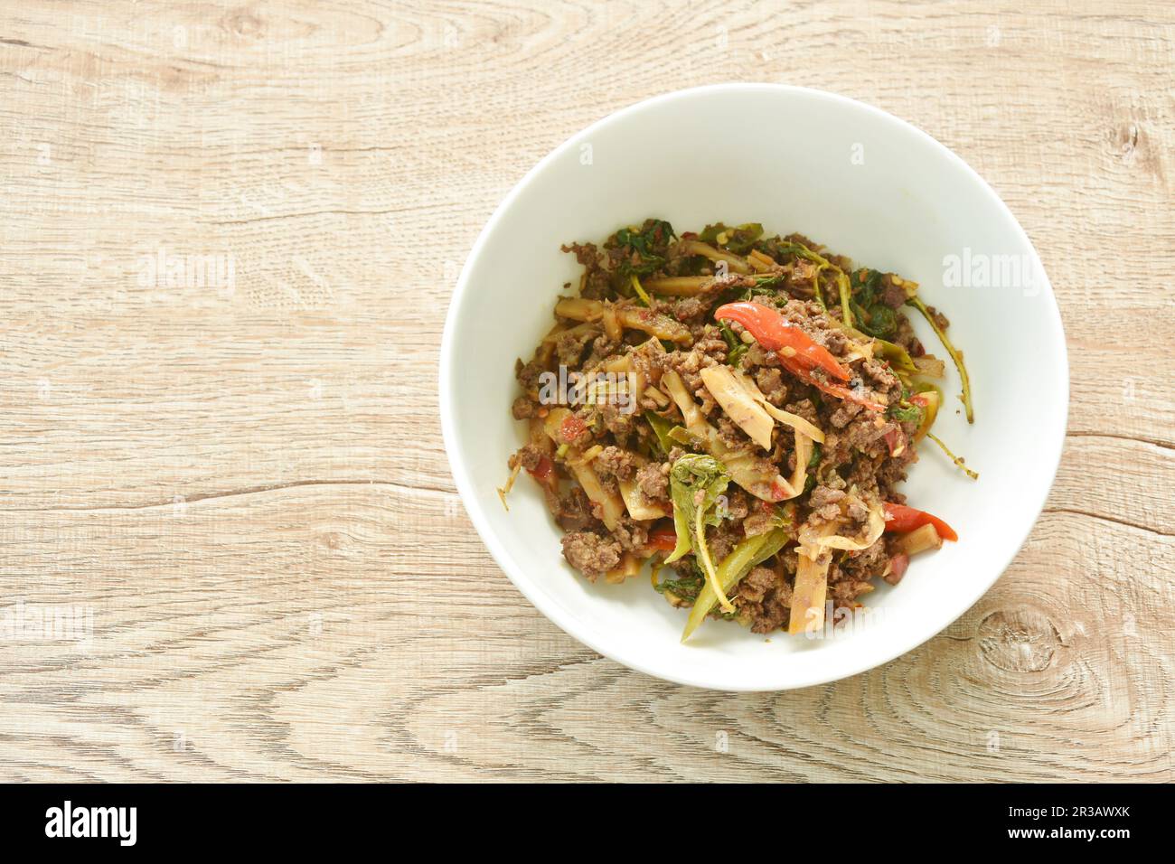 spicy stir fried bamboo shoot and chop beef meat with basil leaf in ...