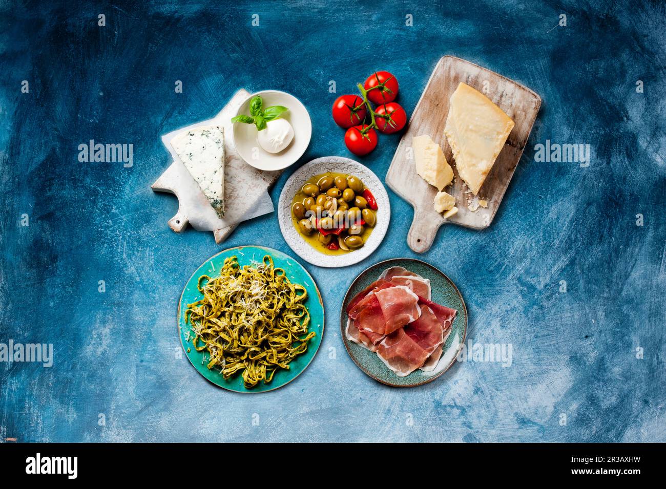 Antipasti: Various types of cheese, pickled olives, ham and pasta Stock ...