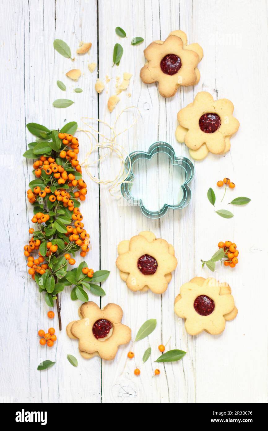 Flower-shaped biscuits with raspberry jam Stock Photo - Alamy