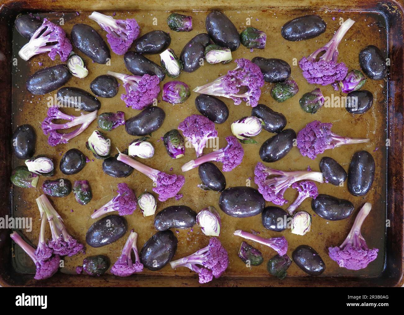 Purple vegetables on roasting pan Stock Photo - Alamy