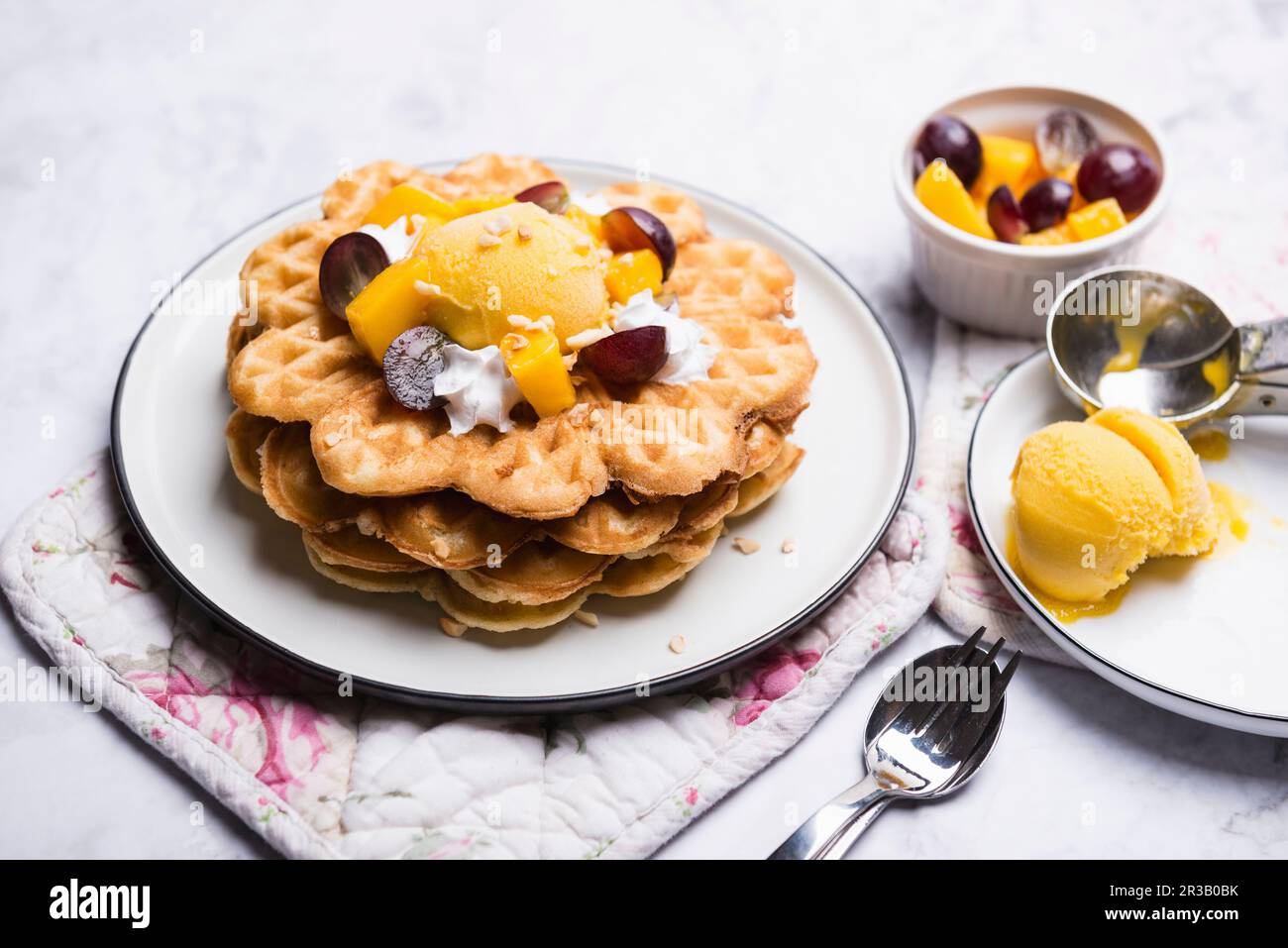 Vegan vanilla waffles with mango sorbet, soya cream and fruit Stock ...