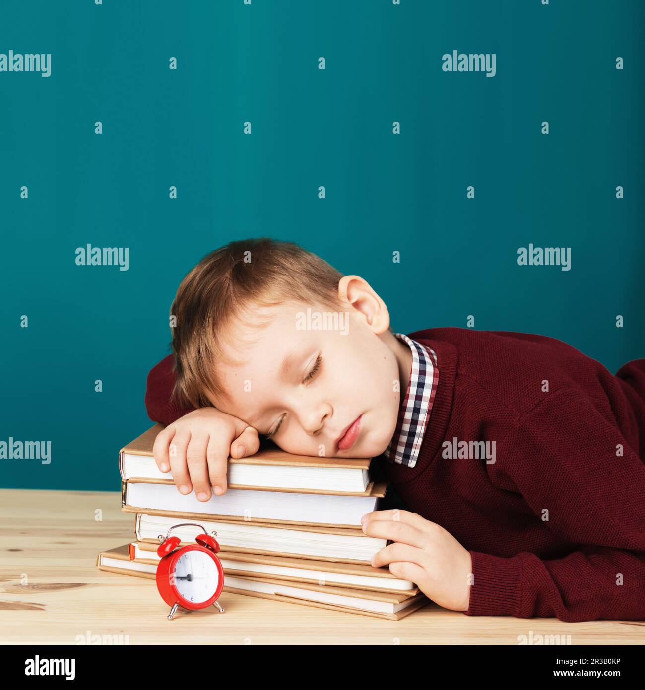 Tired school boy asleep on books. little student sleeping on textbooks ...