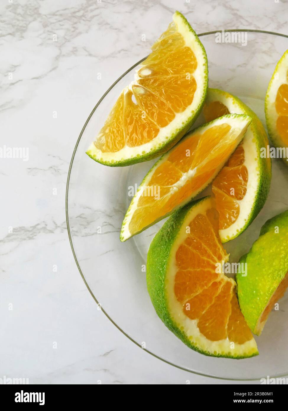 Ugli fruit wedges on a glass plate Stock Photo - Alamy