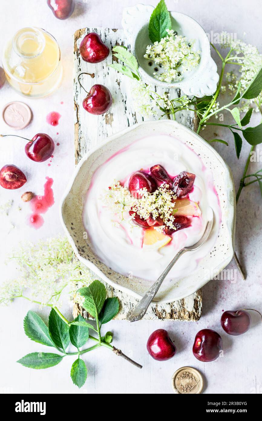 Yogurt with elderflower syrop and cherries Stock Photo - Alamy