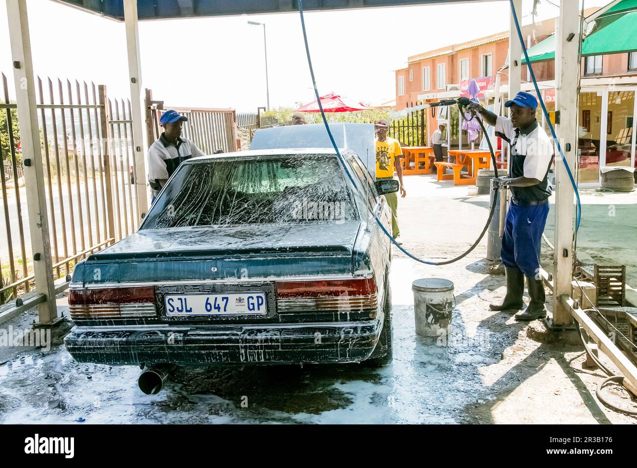 African Man washing a car at a suburban township carwash depot Stock ...