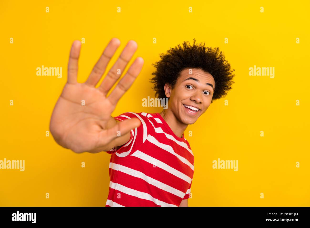 Photo of friendly excited guy dressed red t-shirt smiling waving arm ...