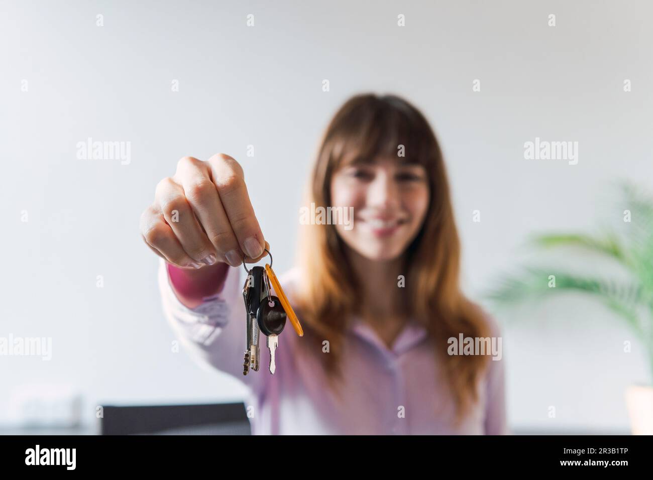 Woman giving house keys in office Stock Photo - Alamy