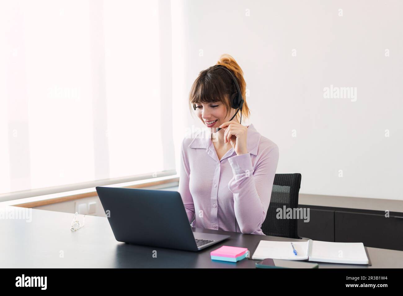 Businesswoman desk using headset hi-res stock photography and images ...