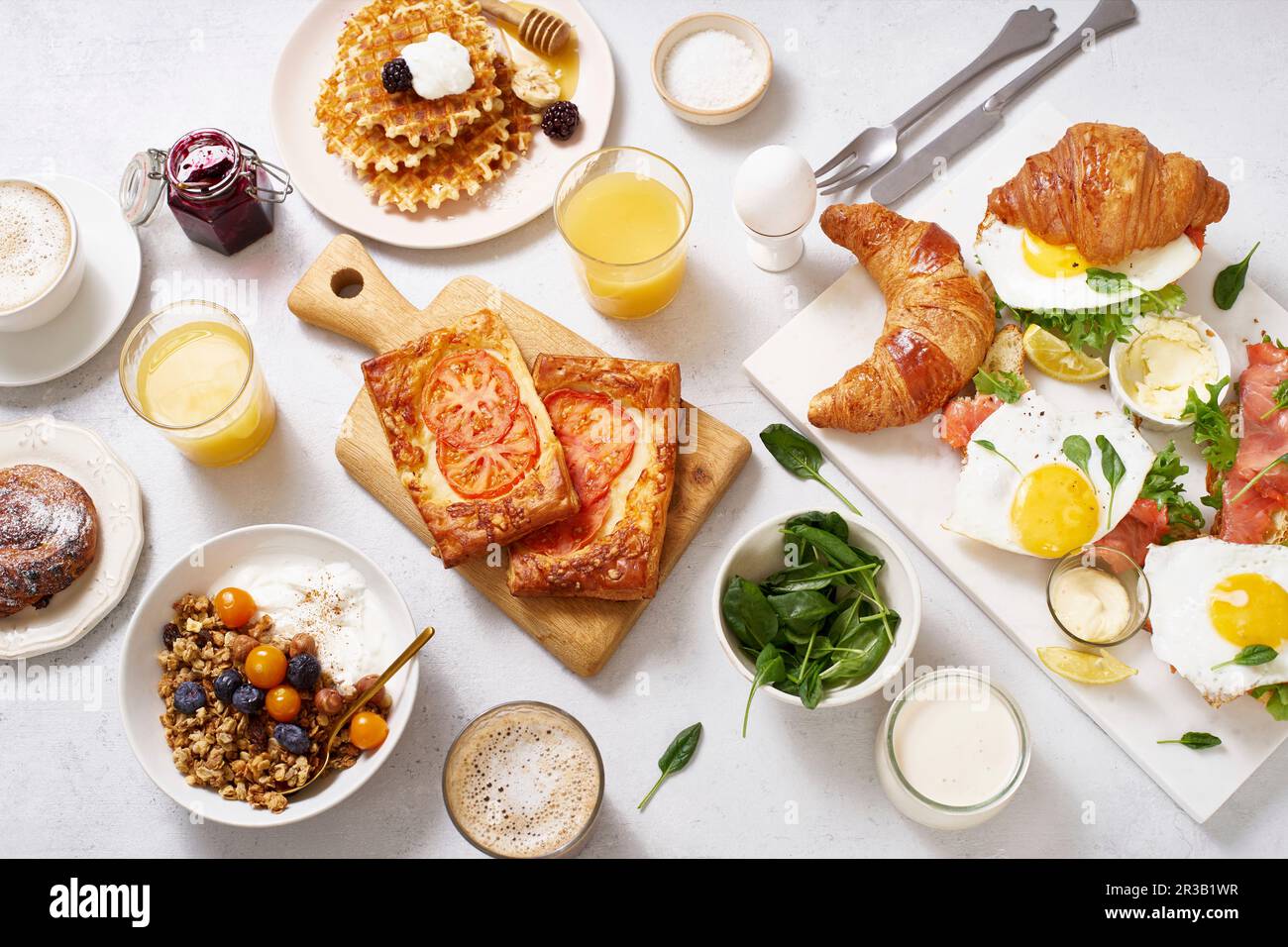 Healthy sunday breakfast with croissants, waffles, eggs, granola and ...