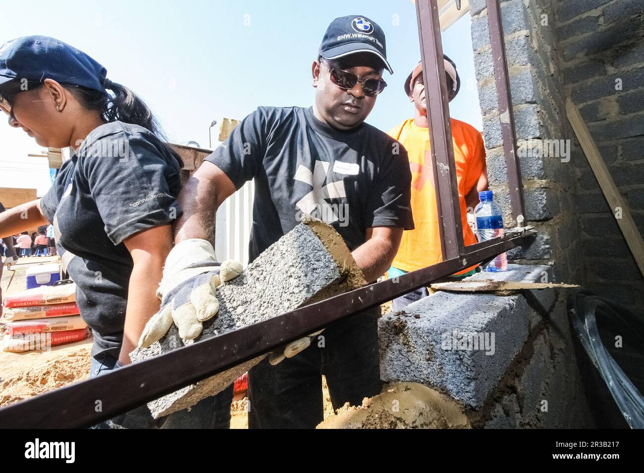 Diverse Community Outreach program helping to build a window frame on a ...