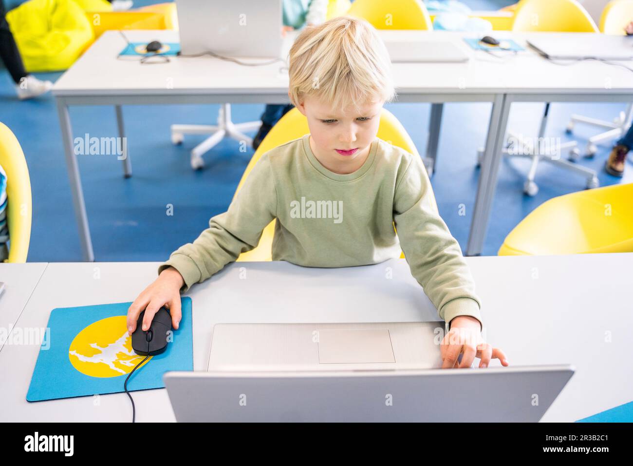 Blond schoolboy in classroom hi-res stock photography and images - Alamy