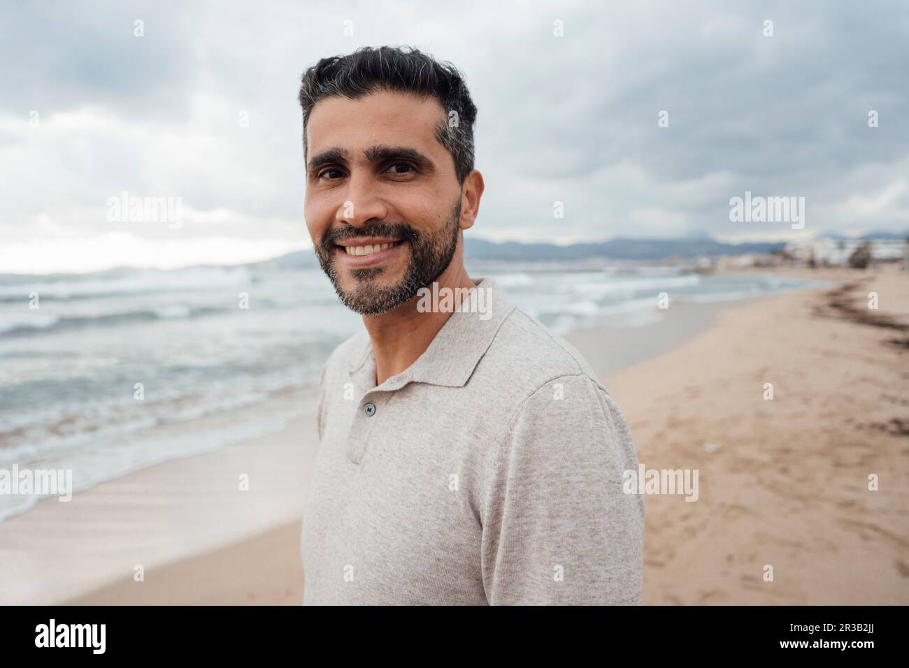 Happy man standing at beach Stock Photo - Alamy