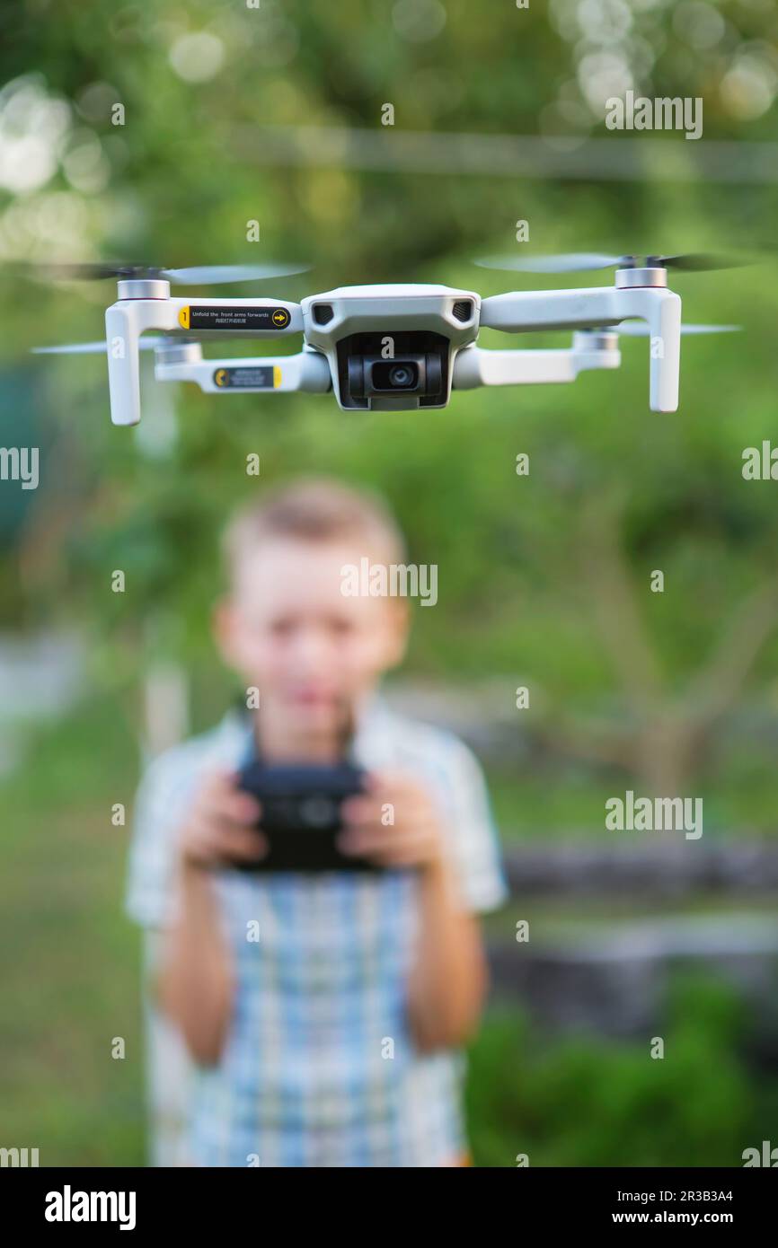 Kid flying drone. Boy operate drones. Child Operating Quadcopter ...