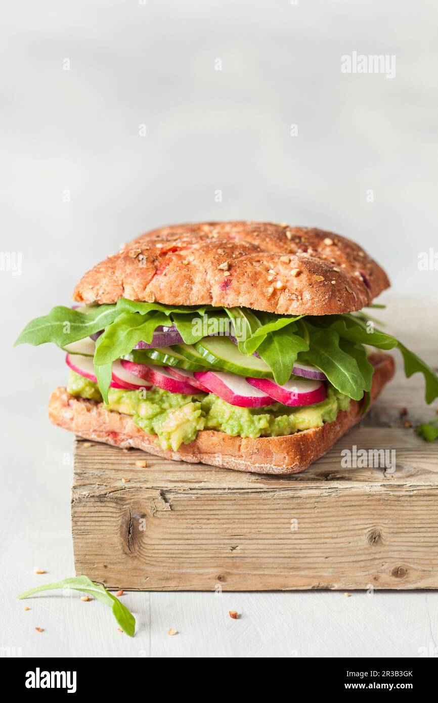 An avocado cream, radish, cucumber and rocket sandwich Stock Photo - Alamy