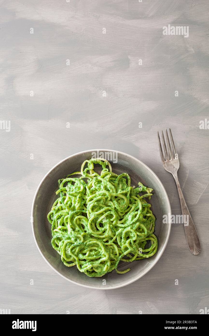 Courgette noodles with vegan rocket and cashew nut pesto Stock Photo ...