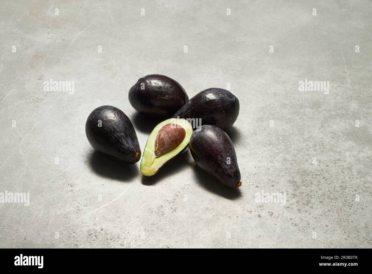 Wild avocados, whole and halved Stock Photo - Alamy
