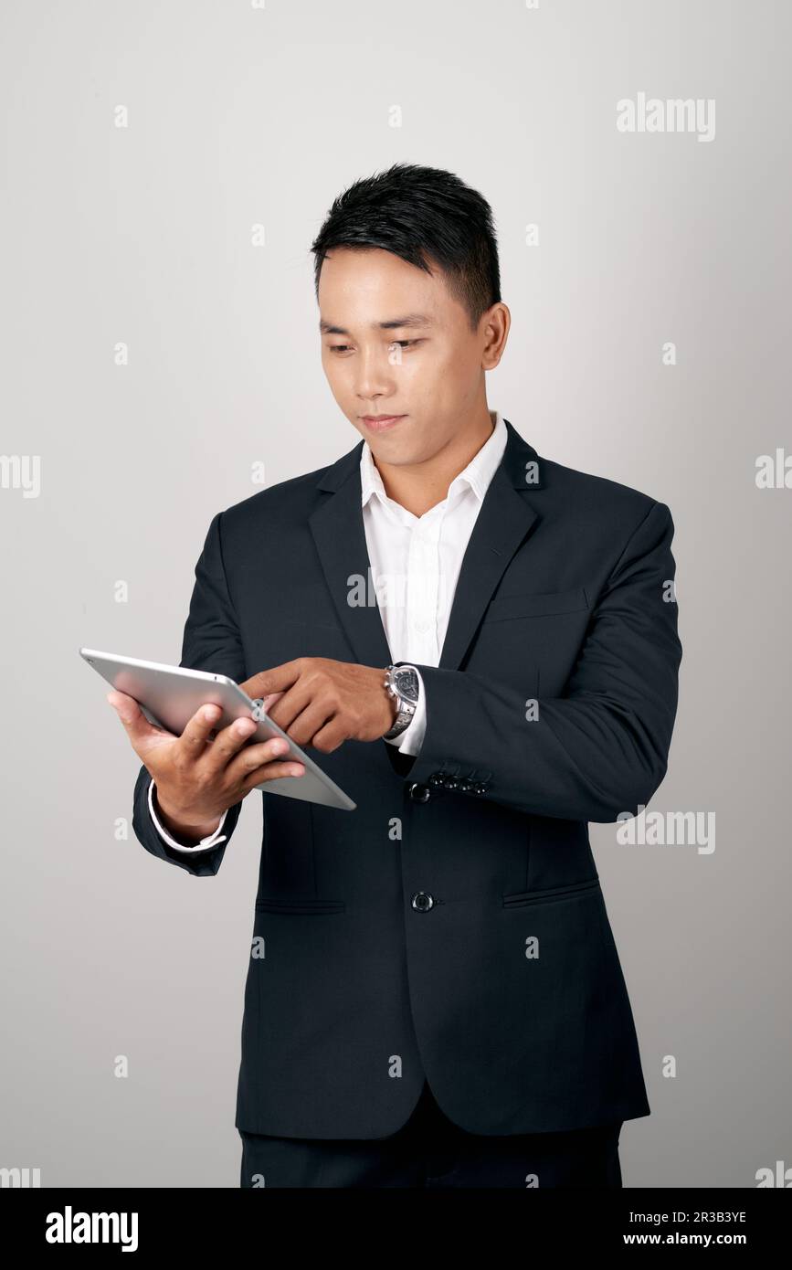 Portrait Of A Smart Asian Confident Businessman Holding Tablet Isolate