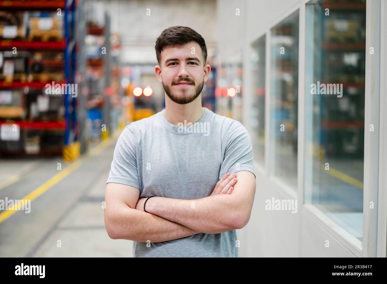 Confident employee with arms crossed at factory Stock Photo - Alamy