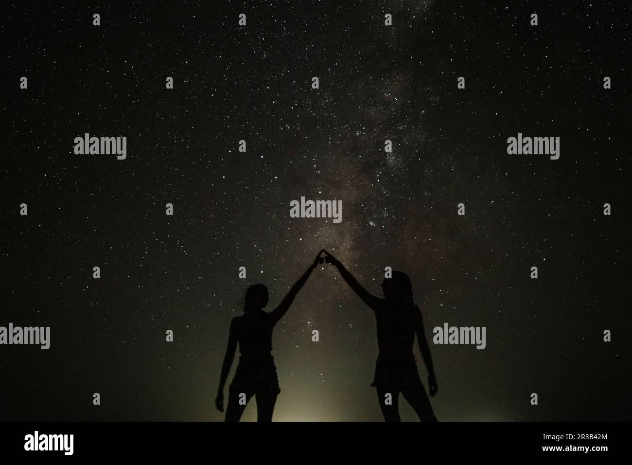 Two women touching fingers and standing in front of stars Stock Photo ...