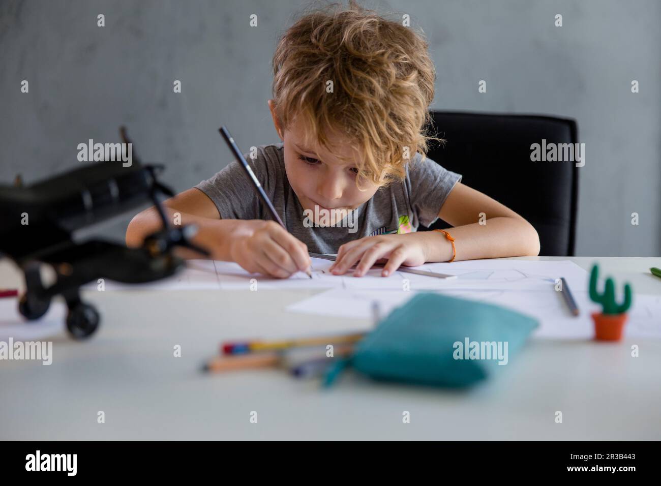 Child writing with pencil hi-res stock photography and images - Alamy