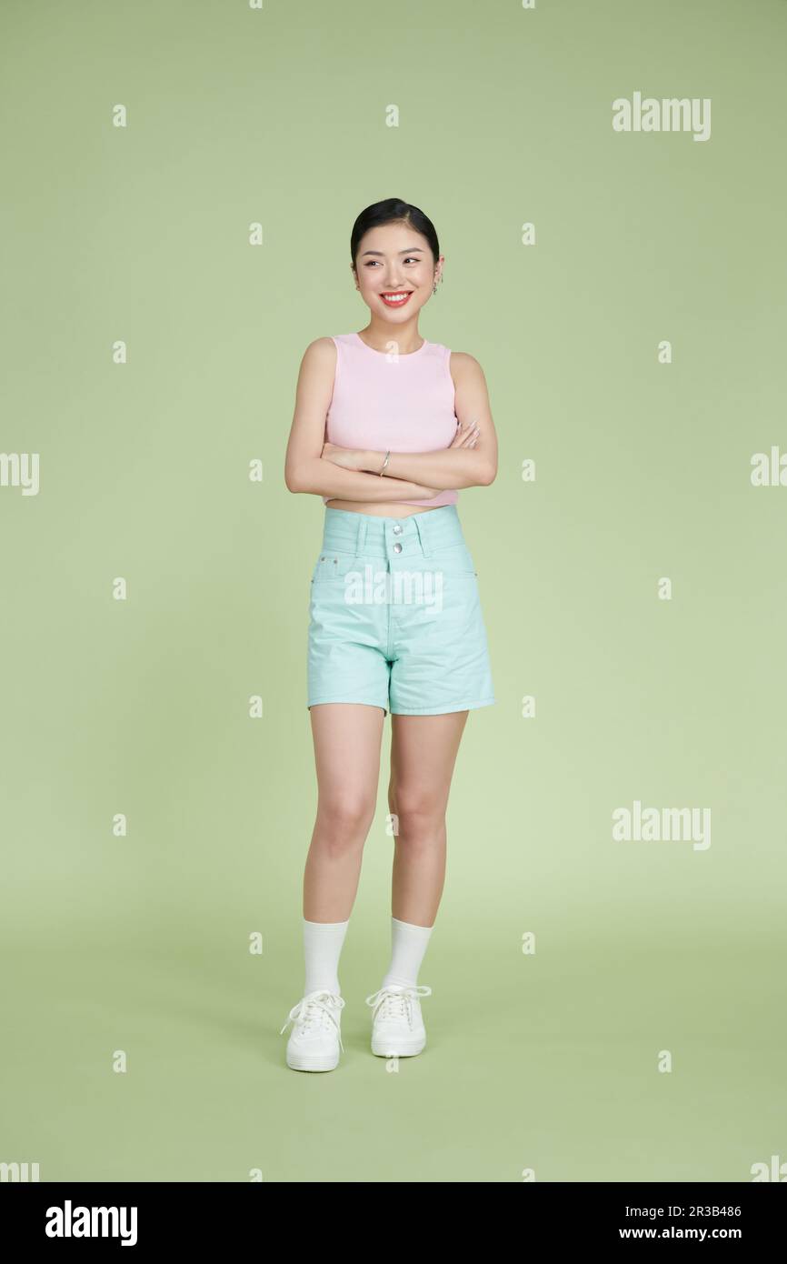 Excellent satisfied glad lady standing with folded arms wearing trendy ...