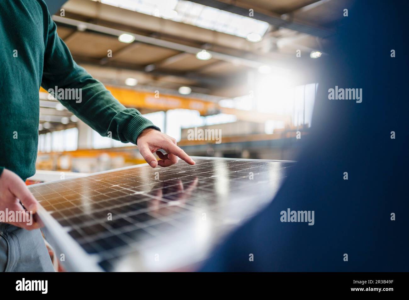 Manager touching solar panel at factory Stock Photo - Alamy