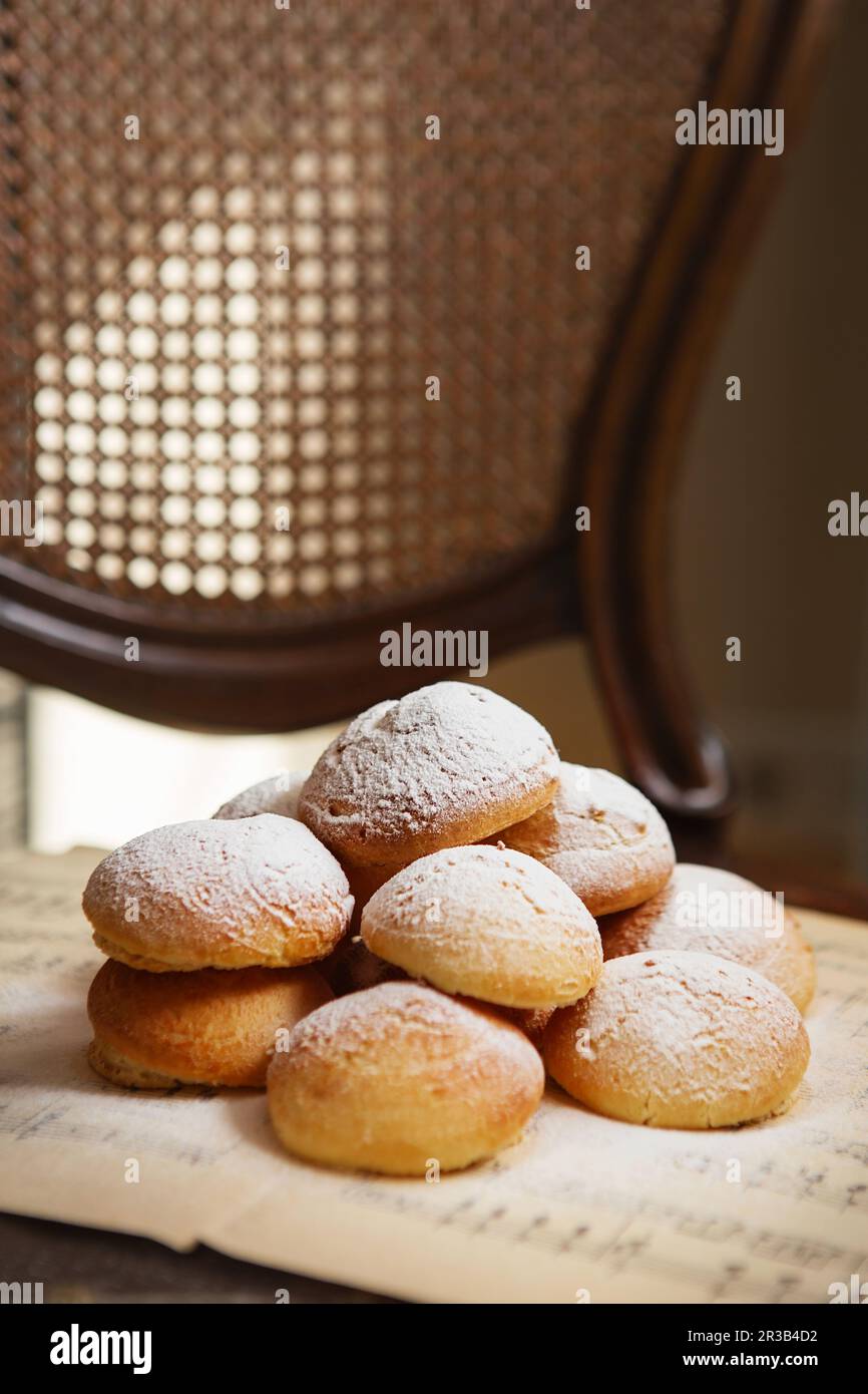 Homemade profiteroles on the music sheet with notes. Profiteroles ...