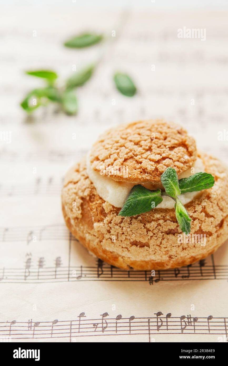 Homemade profiteroles on the music sheet with notes. Profiteroles ...