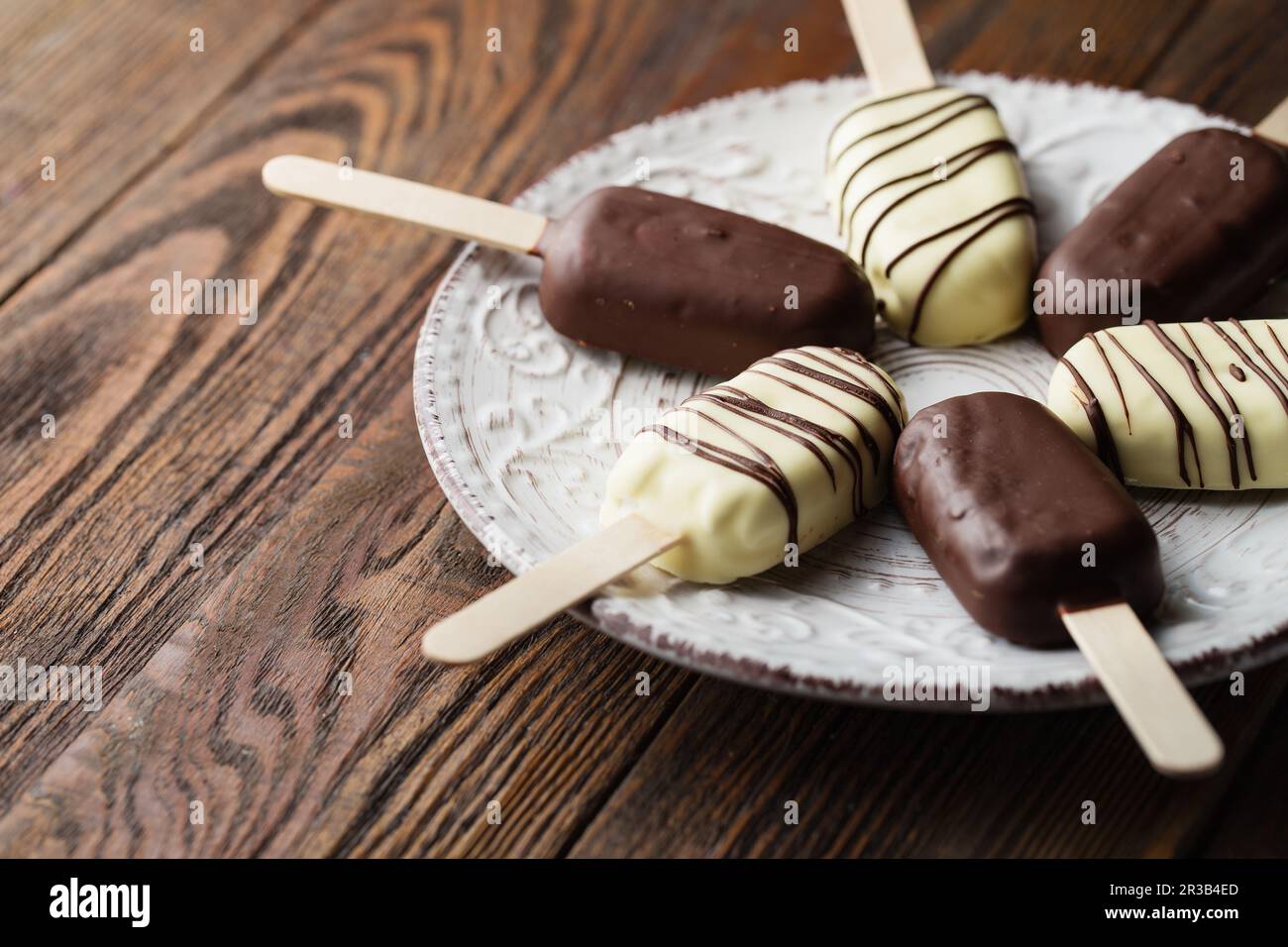 Milk chocolate popsicles on a stick. Ice cream popsicles covered with ...