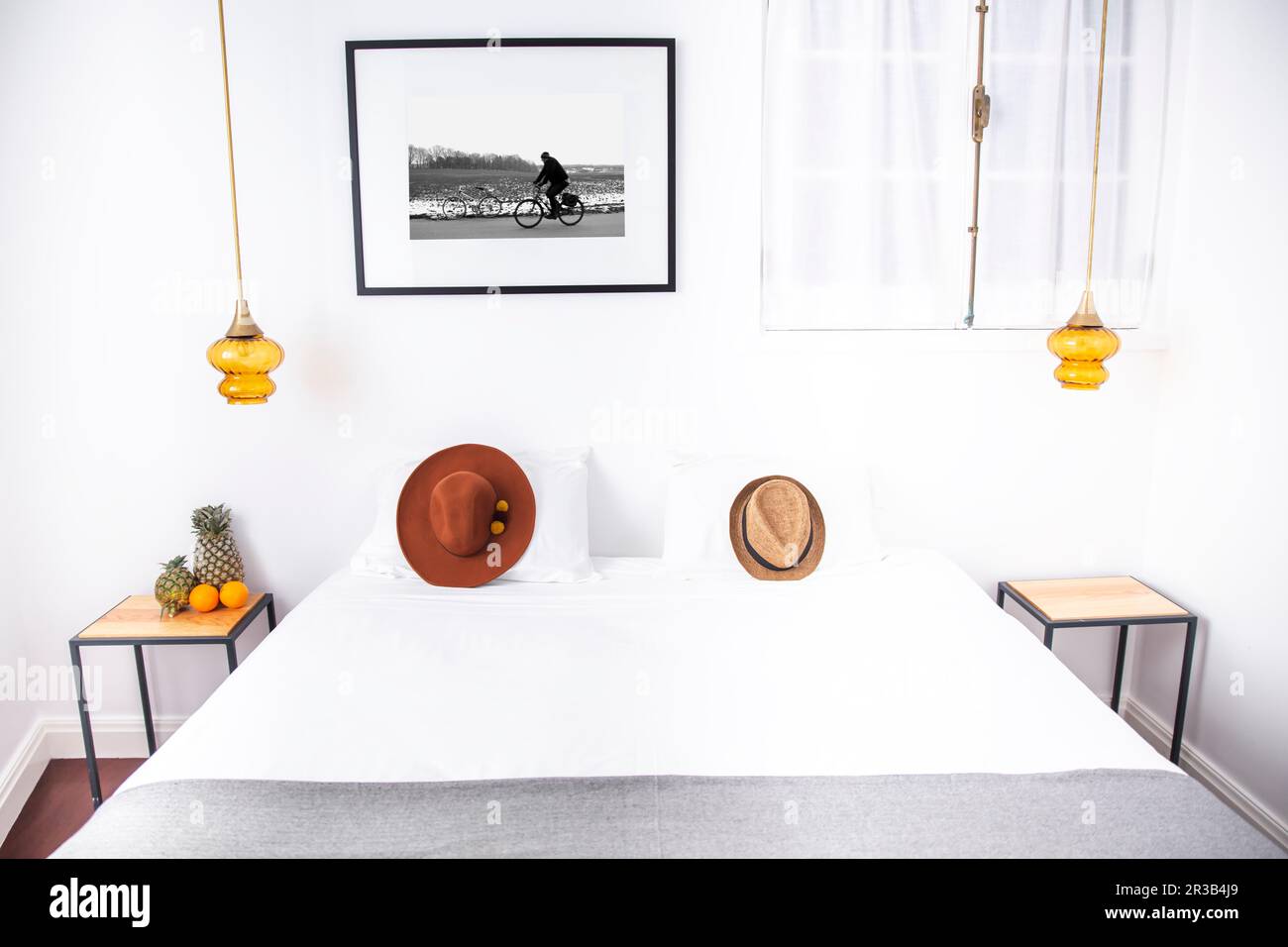 Two hats on bed in hotel room Stock Photo - Alamy