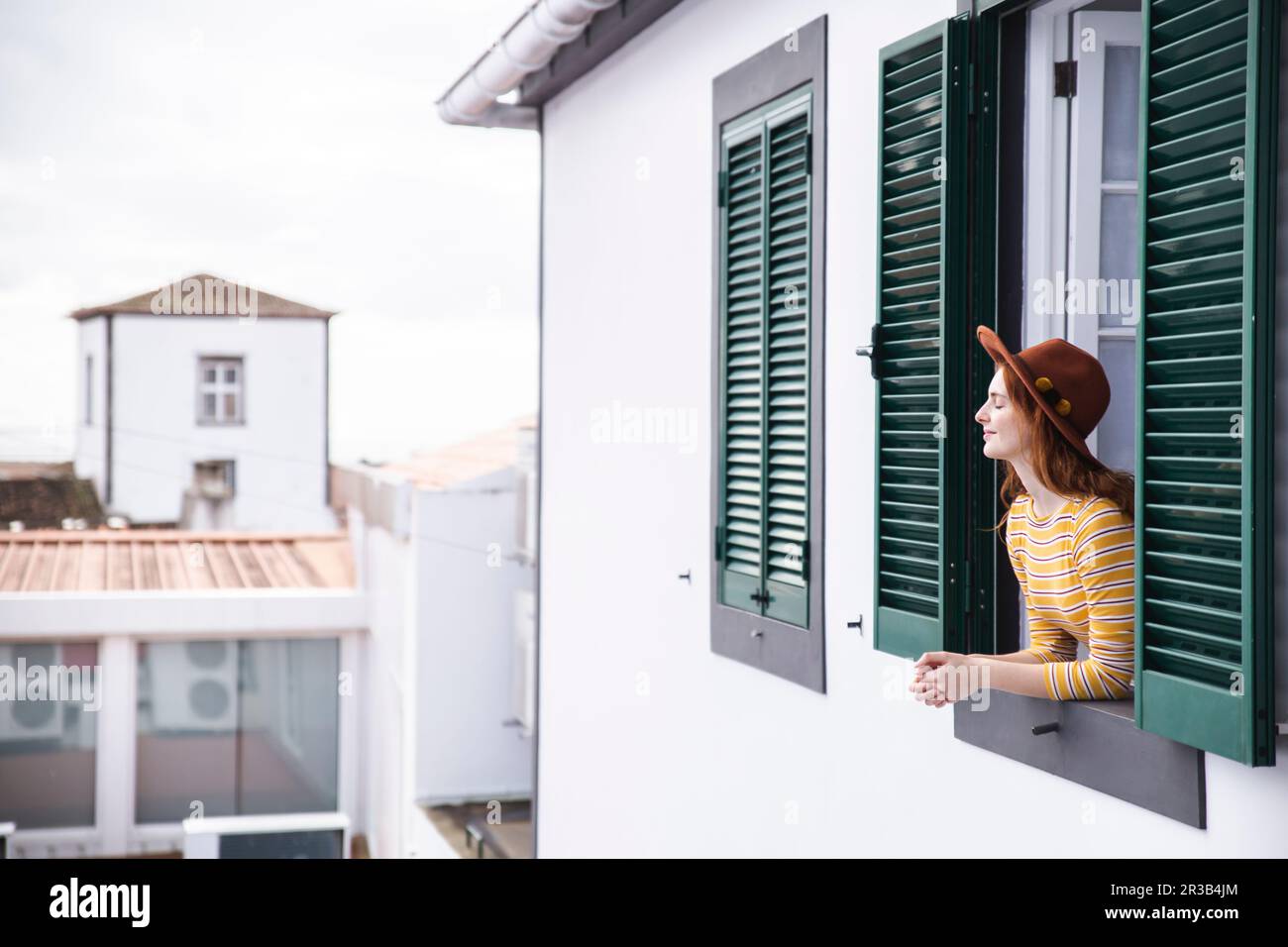 Woman leaning on the window frame hi-res stock photography and images ...