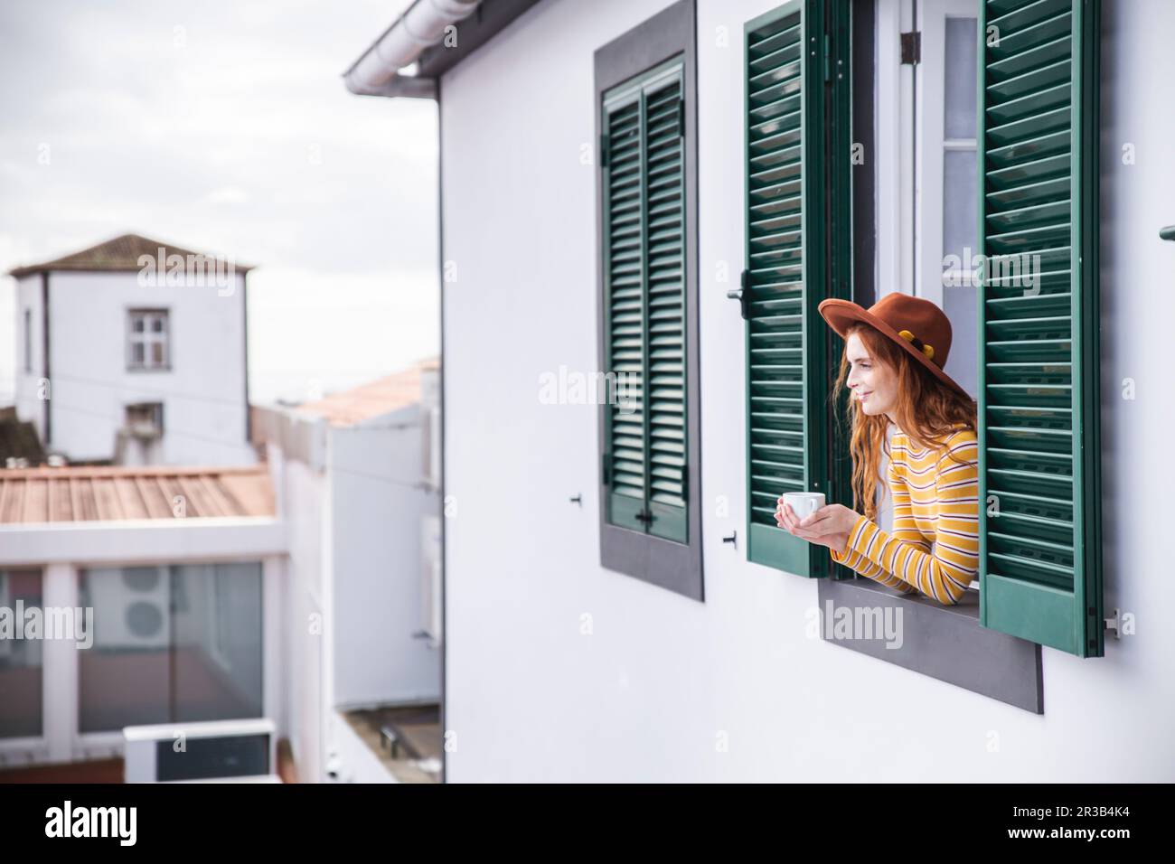 Woman leaning on the window frame hi-res stock photography and images ...